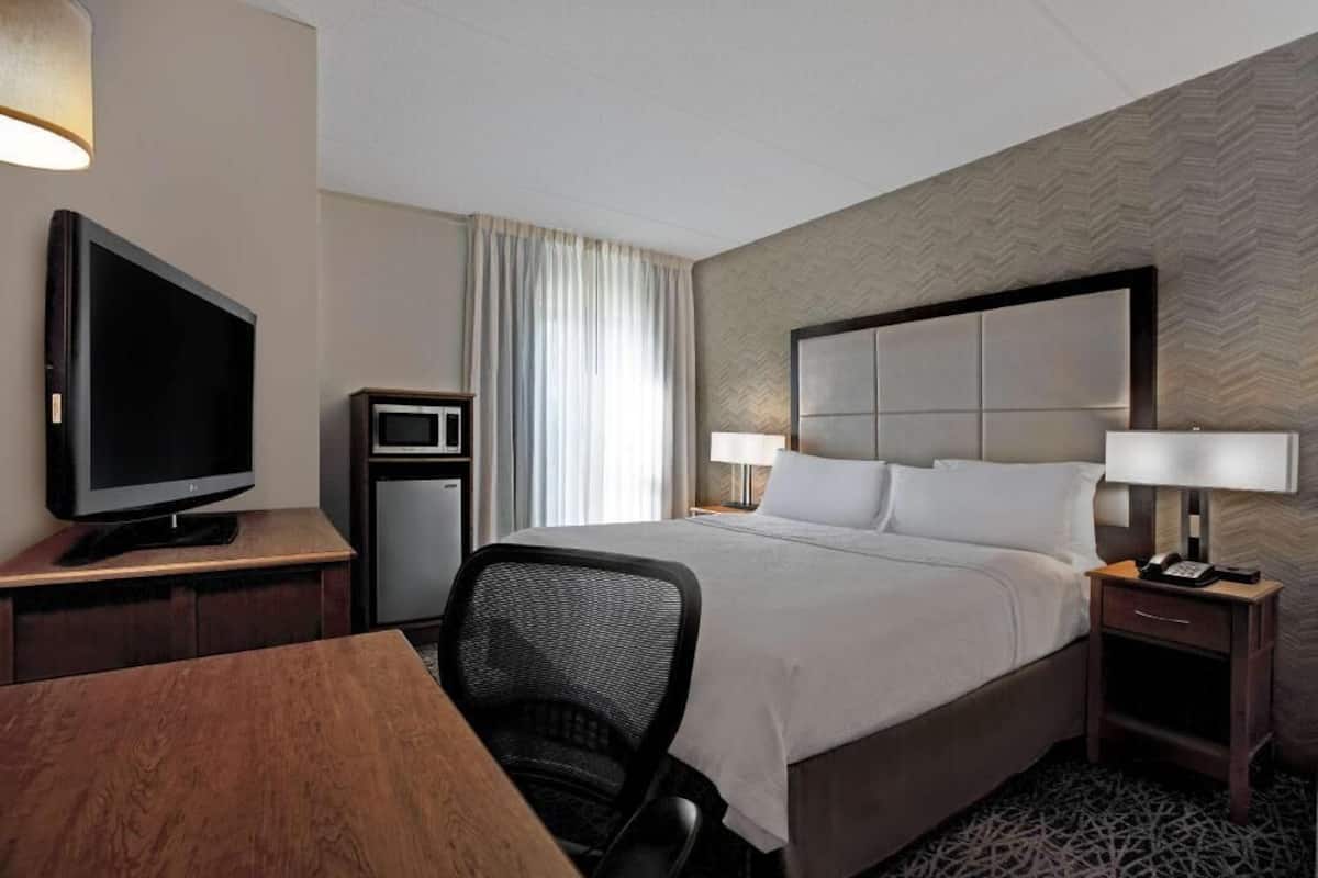 Roupas de cama premium, escrivaninha, cortinas blackout