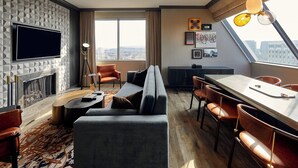 Uma sala de estar moderna com um sofá grande, uma televisão de tela plana, uma lareira e uma área de jantar com uma mesa alta e cadeiras.