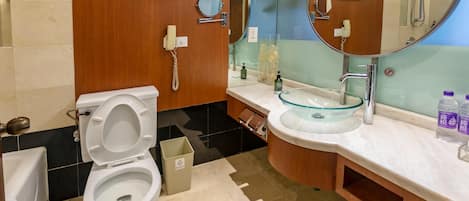 Uma casa de banho moderna com sanita, lavatório e espelhos.