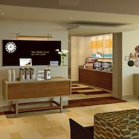 Interior moderno de café com balcão de madeira, um relógio e um letreiro que diz 'MORNING SUN'.