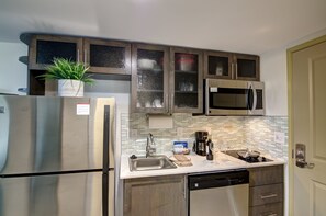 Um frigorífico/congelador grande, um micro-ondas, uma placa de cozinha 