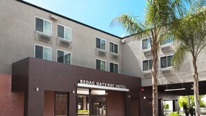 Exterior do Hotel Redac Gateway com design moderno, apresentando um telhado plano, amplas janelas e uma entrada imponente.