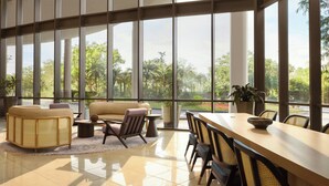 Um espaço amplo e interno, com grandes janelas, uma mesa comprida e assentos confortáveis.