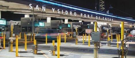Ponto de entrada com uma placa indicando 'SAN YSIDRO PORT OF ENTRY'.