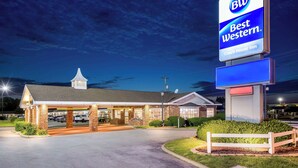 Um hotel com um grande letreiro que diz "Best Western Coach House Inn".