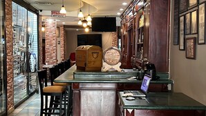Cozinha moderna com ilha central, iluminação pendente e vista para o exterior.