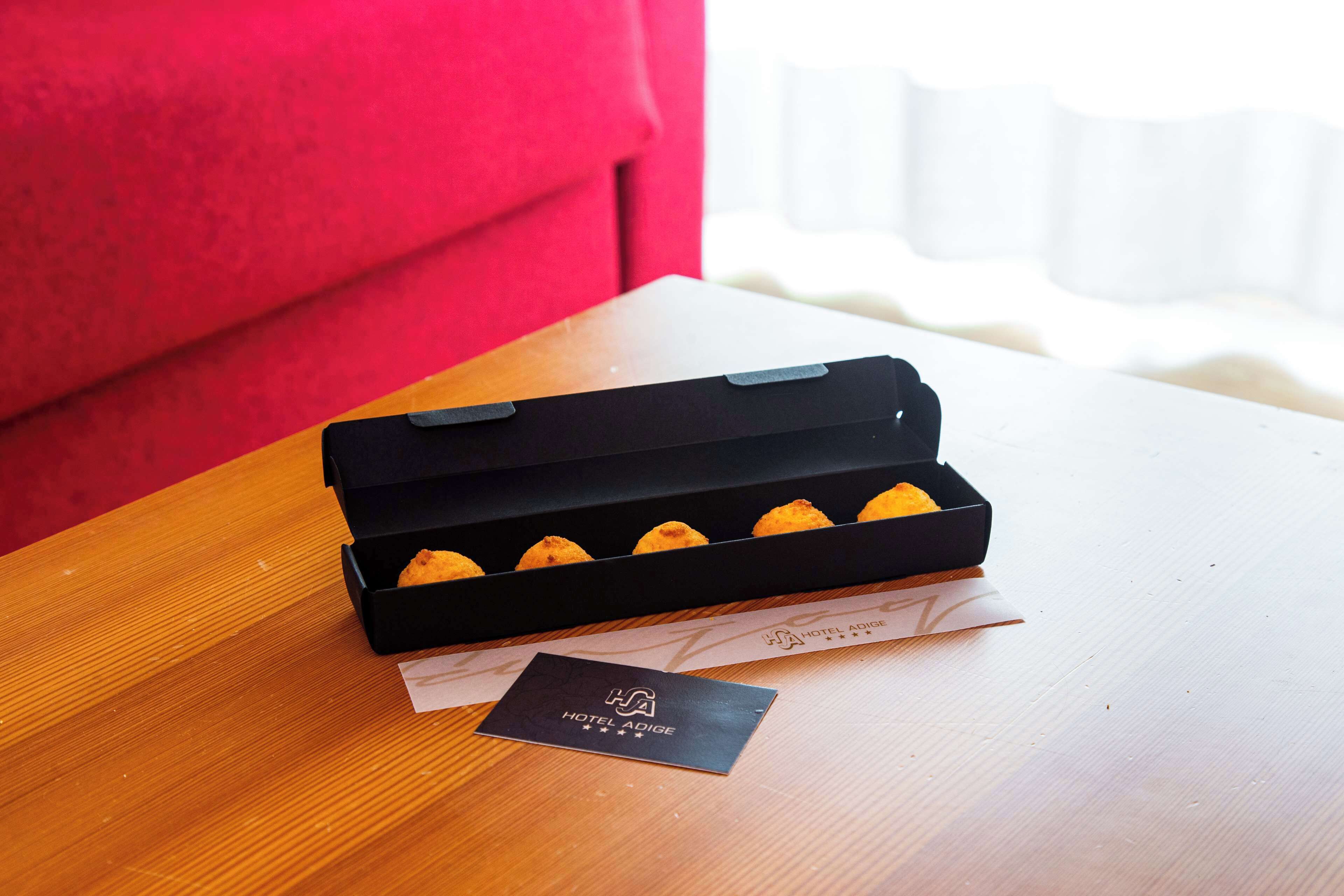 Uma caixa preta com um cartão sobre uma mesa de madeira.
