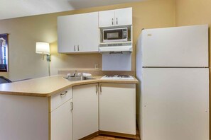 Um frigorífico, um micro-ondas, uma placa de cozinha 