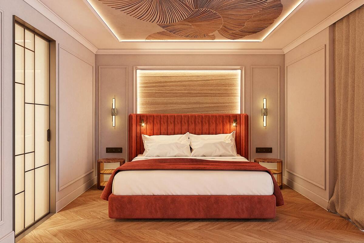 Quarto moderno com cama grande, cabeceira de madeira e iluminação ambiente.