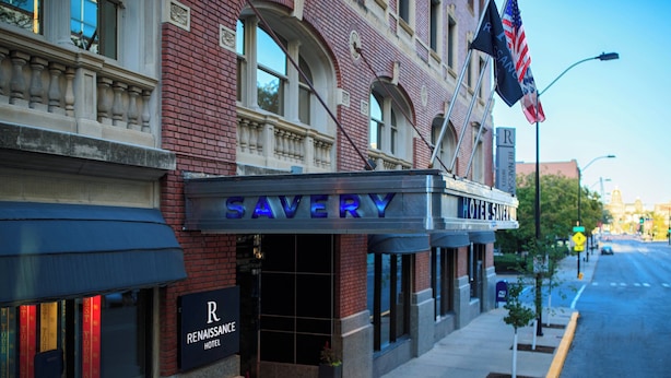 A hotel facade with a prominent sign reading "SAVERY HOTEL" and "Renaissance Hotel."
