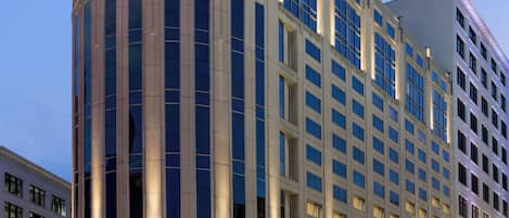 Um hotel com vários andares e uma placa de destaque com a inscrição 'CROWNE PLAZA'.