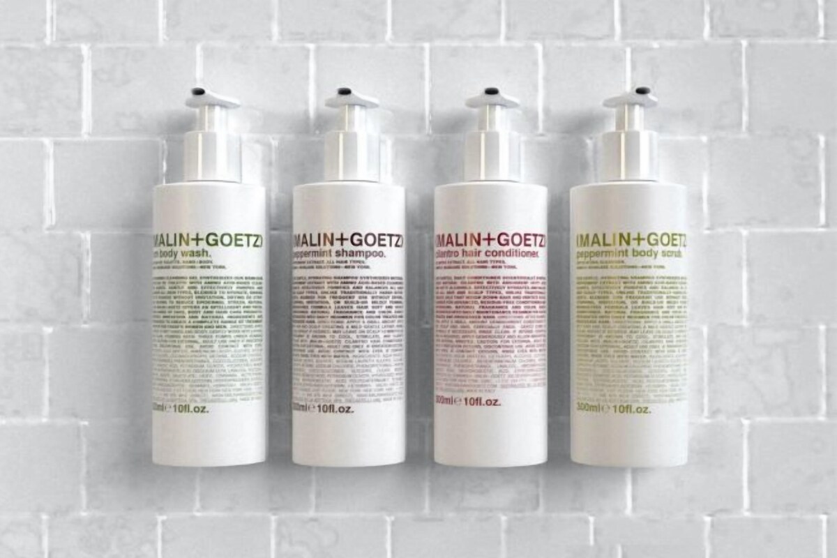 Quatro frascos de banho, shampoo e condicionador MALIN+GOETZ.