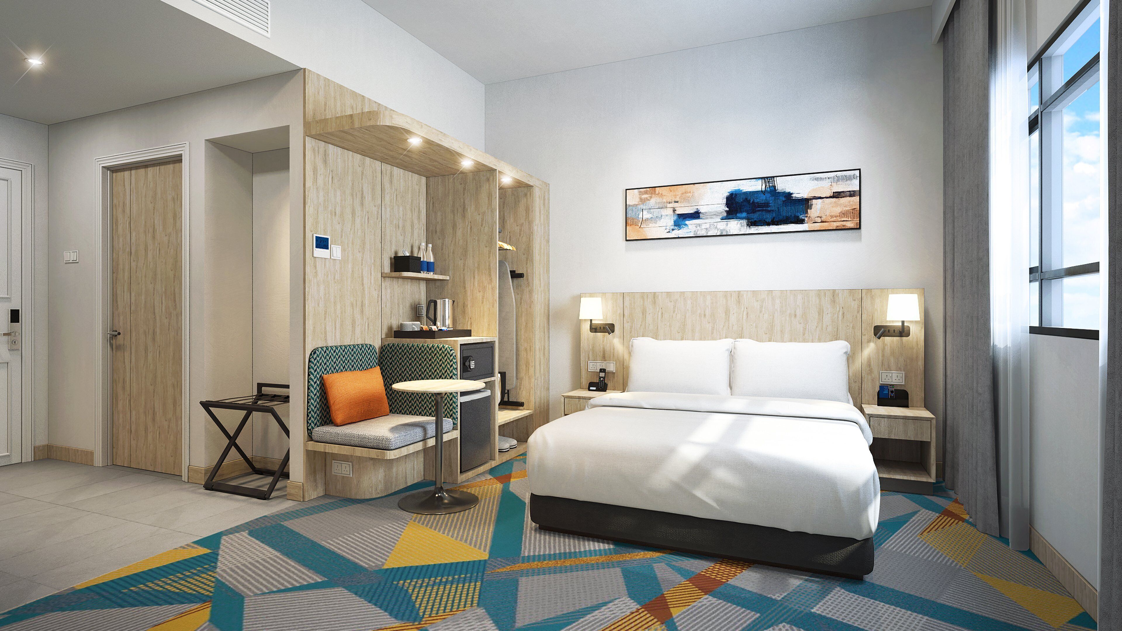 Quarto de hotel moderno com uma cama grande, área de estar com uma mesa e um quadro na parede.