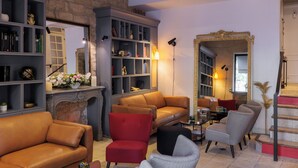 Uma sala de estar aconchegante com sofás de couro, lareira e estante de livros.