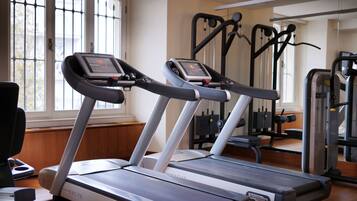 Academia com esteiras e equipamentos de ginástica.