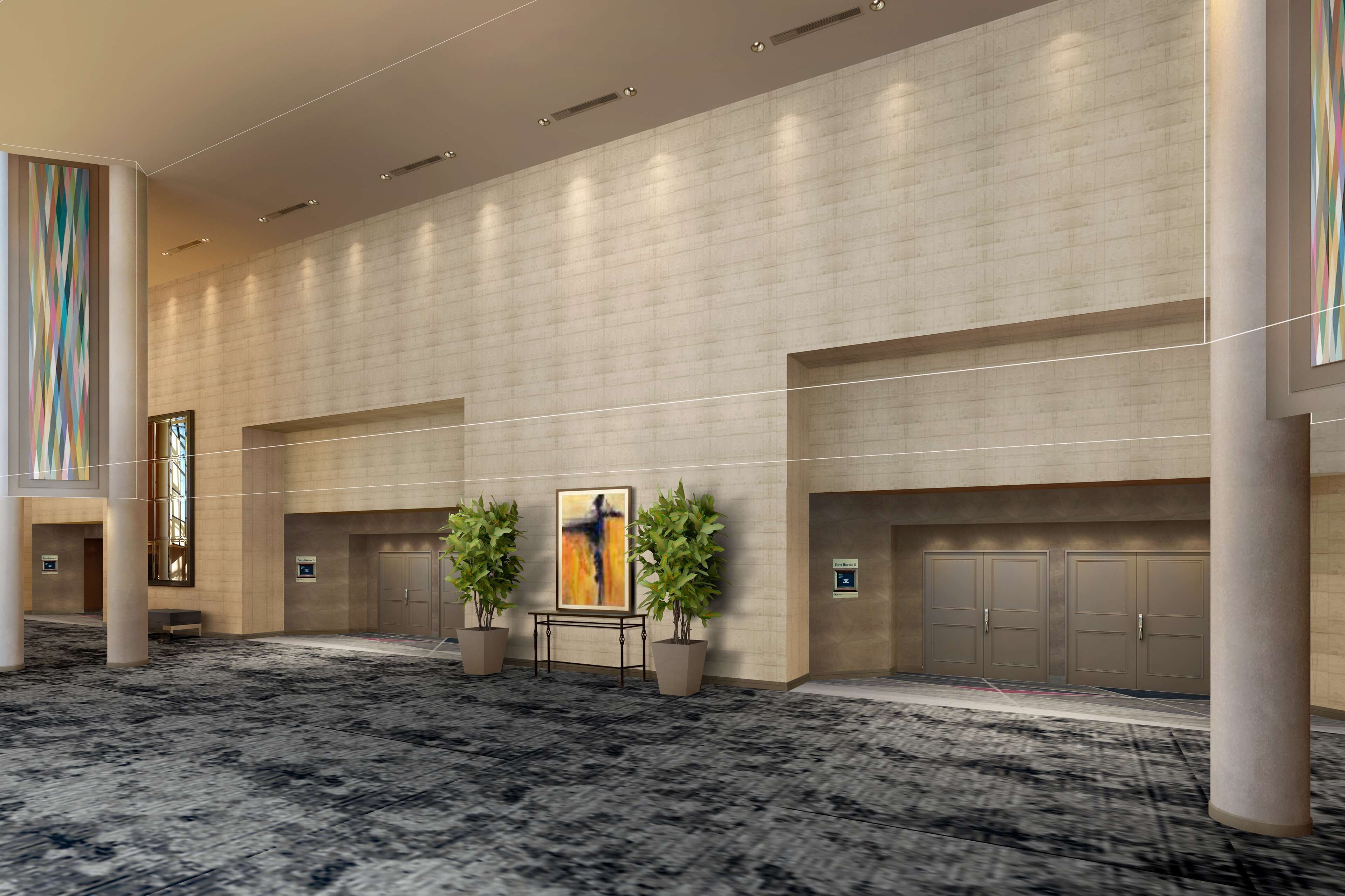 Um hall amplo com teto alto, carpete estampado e design moderno.