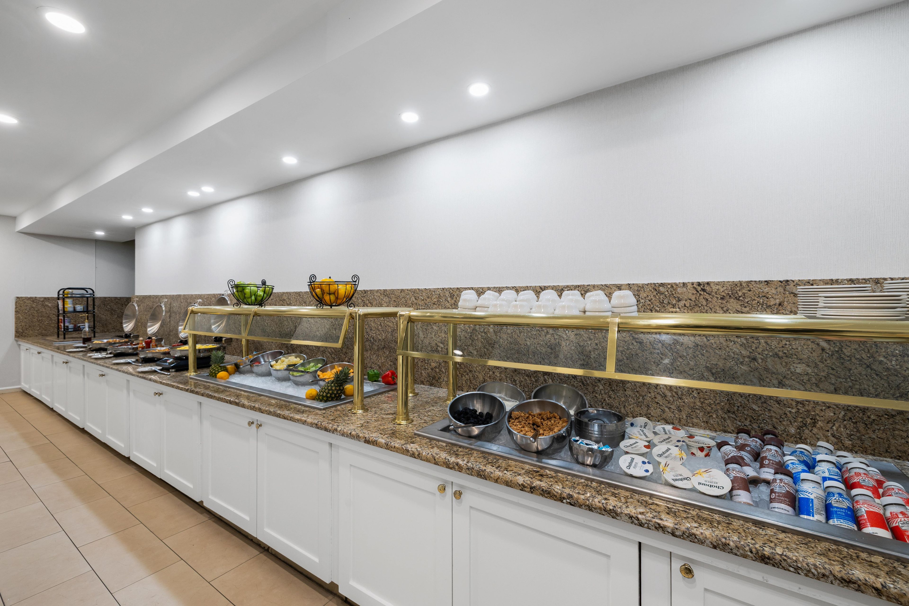 Uma mesa de buffet com diversos alimentos e bebidas.