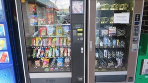 Duas máquinas de venda automática com uma variedade de lanches e bebidas.