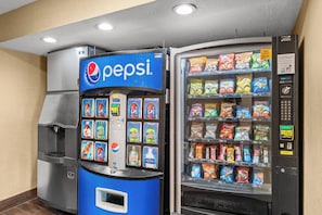 Máquina automática de bebidas com marca Pepsi e máquina de vendas de snacks.