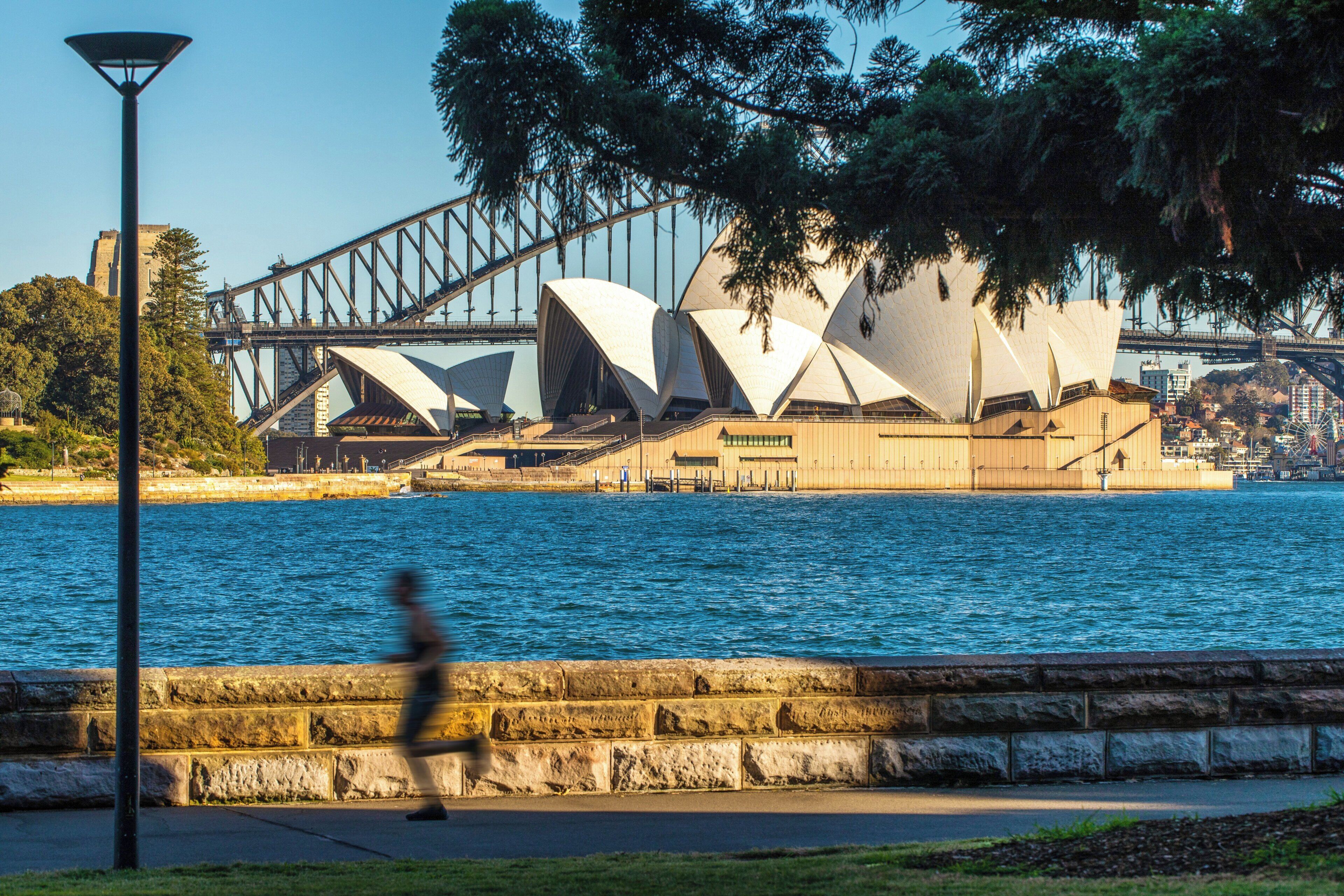 Vista para a orla marítima, com uma ponte e a Ópera de Sydney.