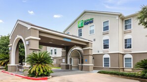 Edifício Holiday Inn Express com entrada coberta, sinalização clara e estacionamento.
