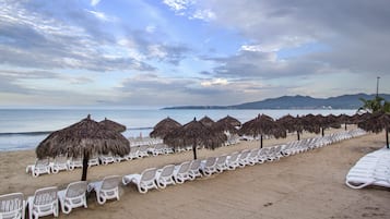 Na praia, espreguiçadeiras, toalhas de praia, 2 bares na praia