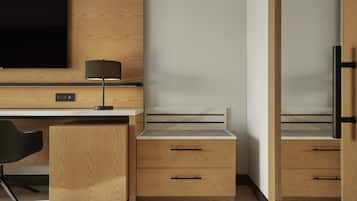 Quarto moderno com escrivaninha de madeira, cadeira preta, televisão e abajur.