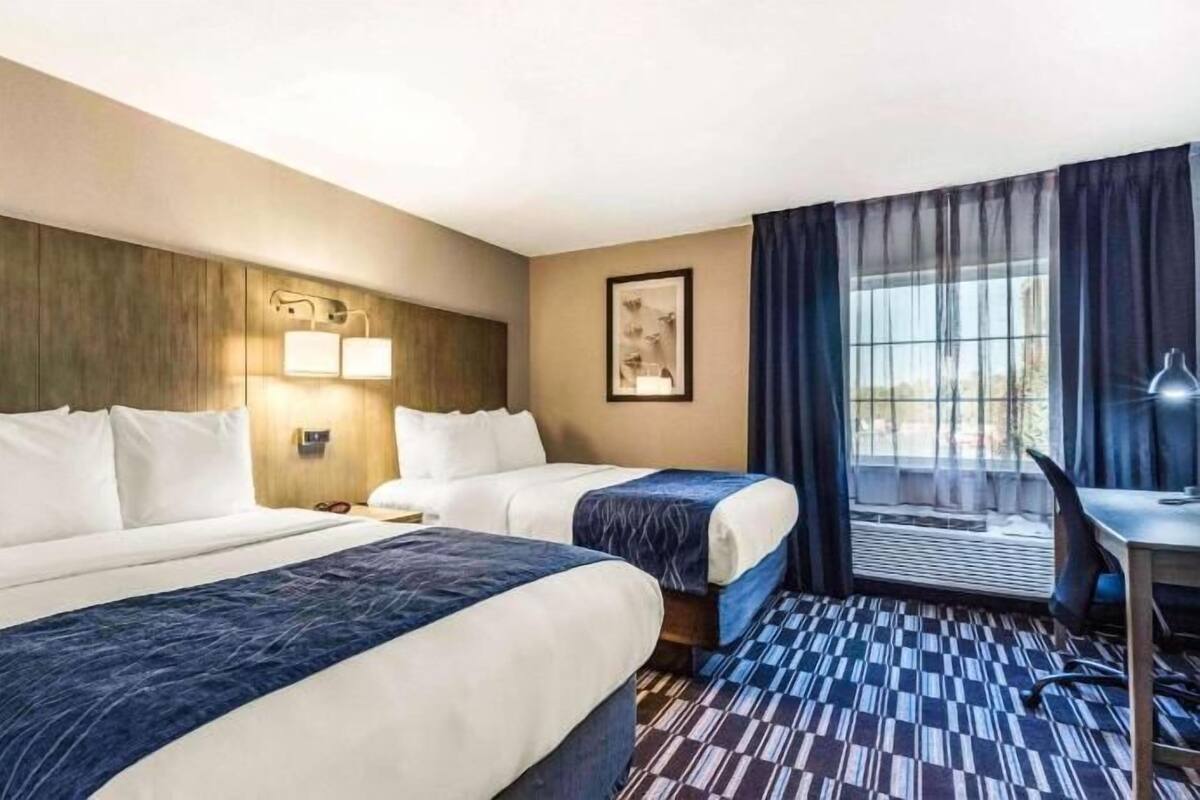 Camas com colchões pillow-top, escrivaninha, cortinas blackout