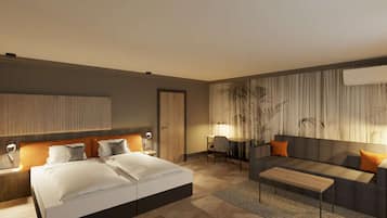 Quarto de hotel moderno com uma cama grande, um sofá, uma escrivaninha e uma cadeira.