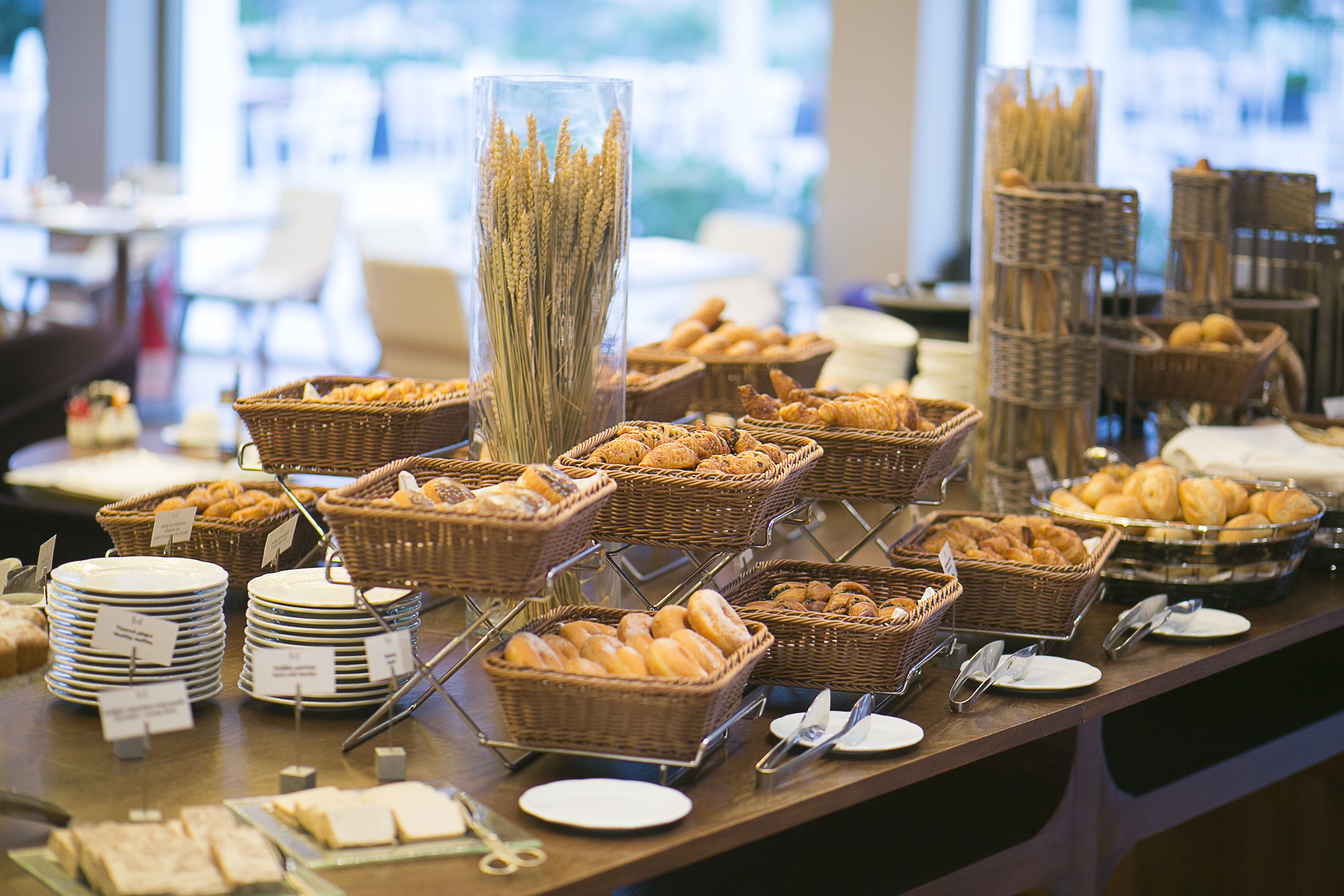 Uma mesa de buffet com diversos alimentos e cestas.