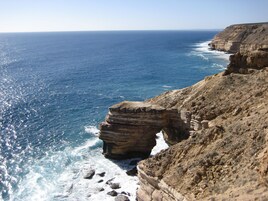Um penhasco costeiro com vista clara do oceano.