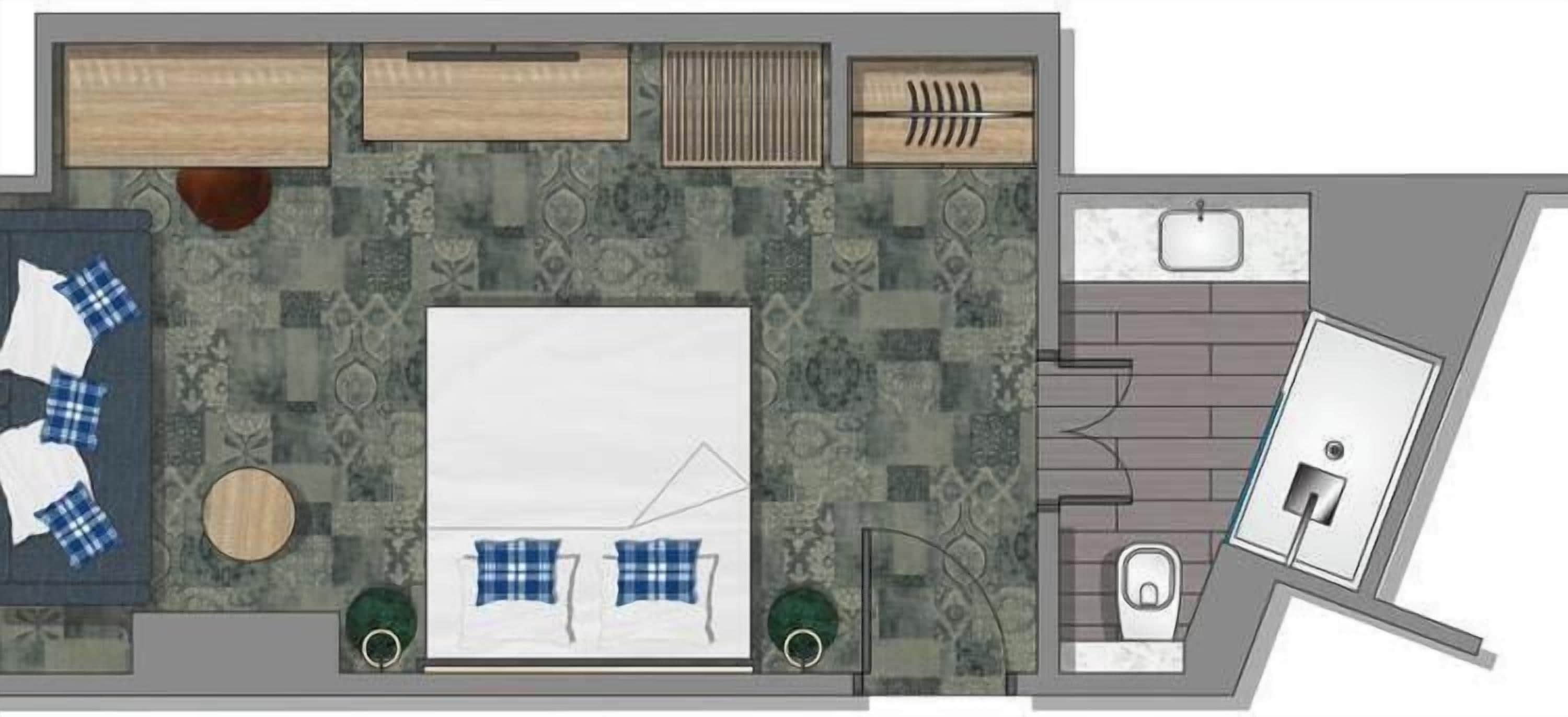 Layout de quarto de hotel com cama, área de estar e banheiro.