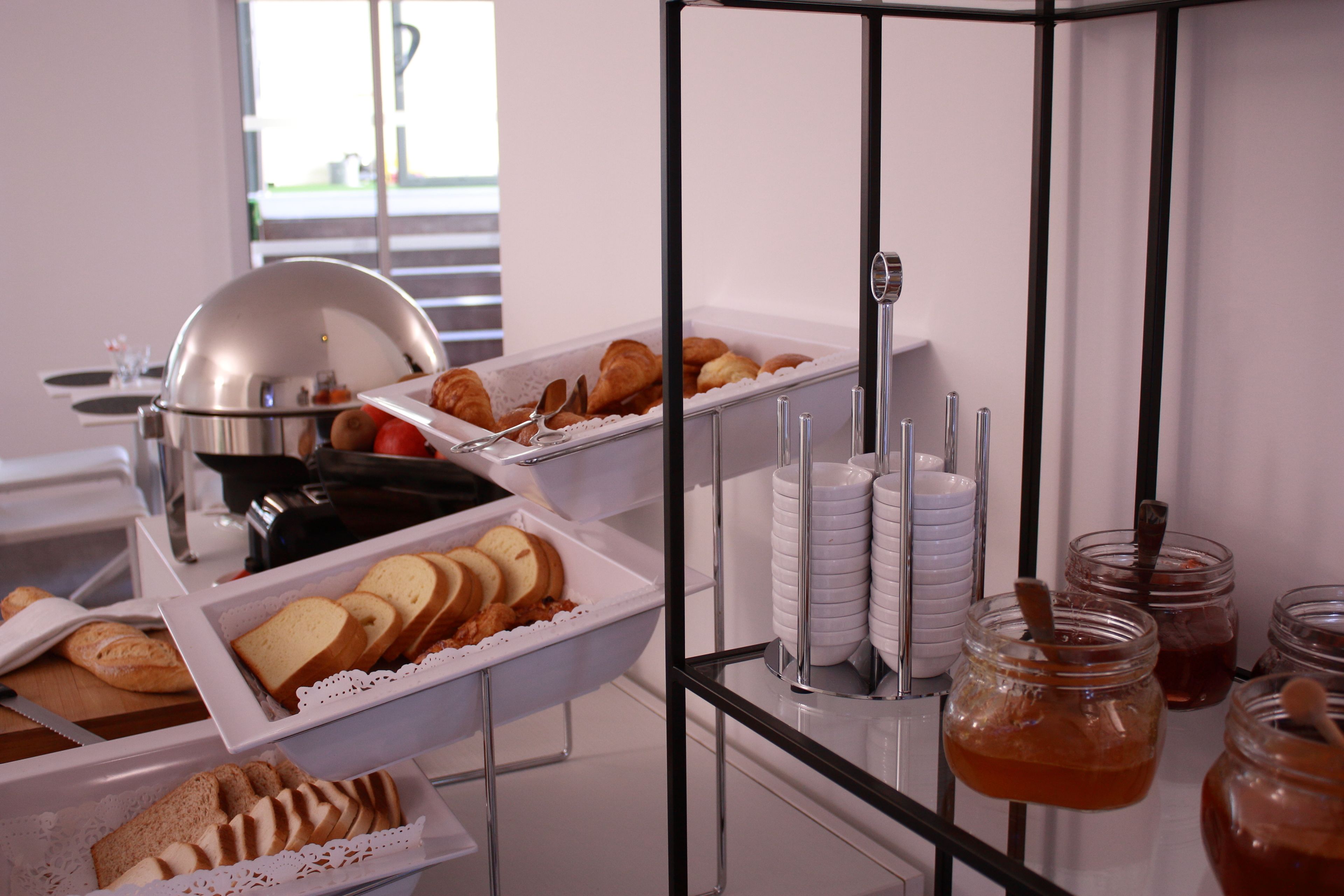 Uma mesa de buffet com diversos alimentos e acompanhamentos.