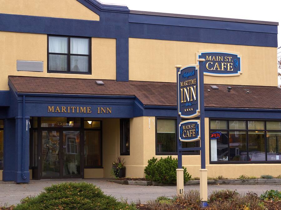 Um edifício com uma placa indicando 'Maritime Inn' e 'Main St. Cafe'.
