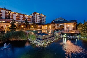 Um resort com piscina, área de spa e vários edifícios com varandas.