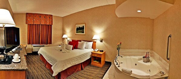 Quarto, 1 cama king-size, banheira de hidromassagem | Secretária, ferro/tábua de engomar, Wi-fi grátis