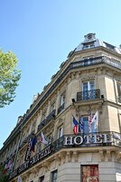 Exterior do Hotel Royal Saint-Michel, com arquitetura clássica, varandas ornamentadas e várias bandeiras.
