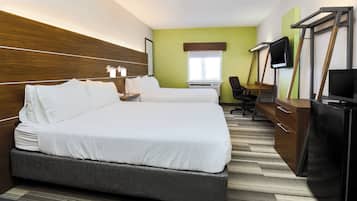 Quarto de hotel com duas camas, uma escrivaninha, uma cadeira, televisão e minibar.