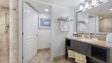 Casa de banho moderna com chuveiro, lavatório com espelho e um porta-toalhas.