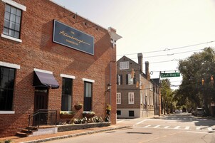 Um edifício de tijolos com toldo preto e uma placa que diz 'The Arsonborough Charlestown'.
