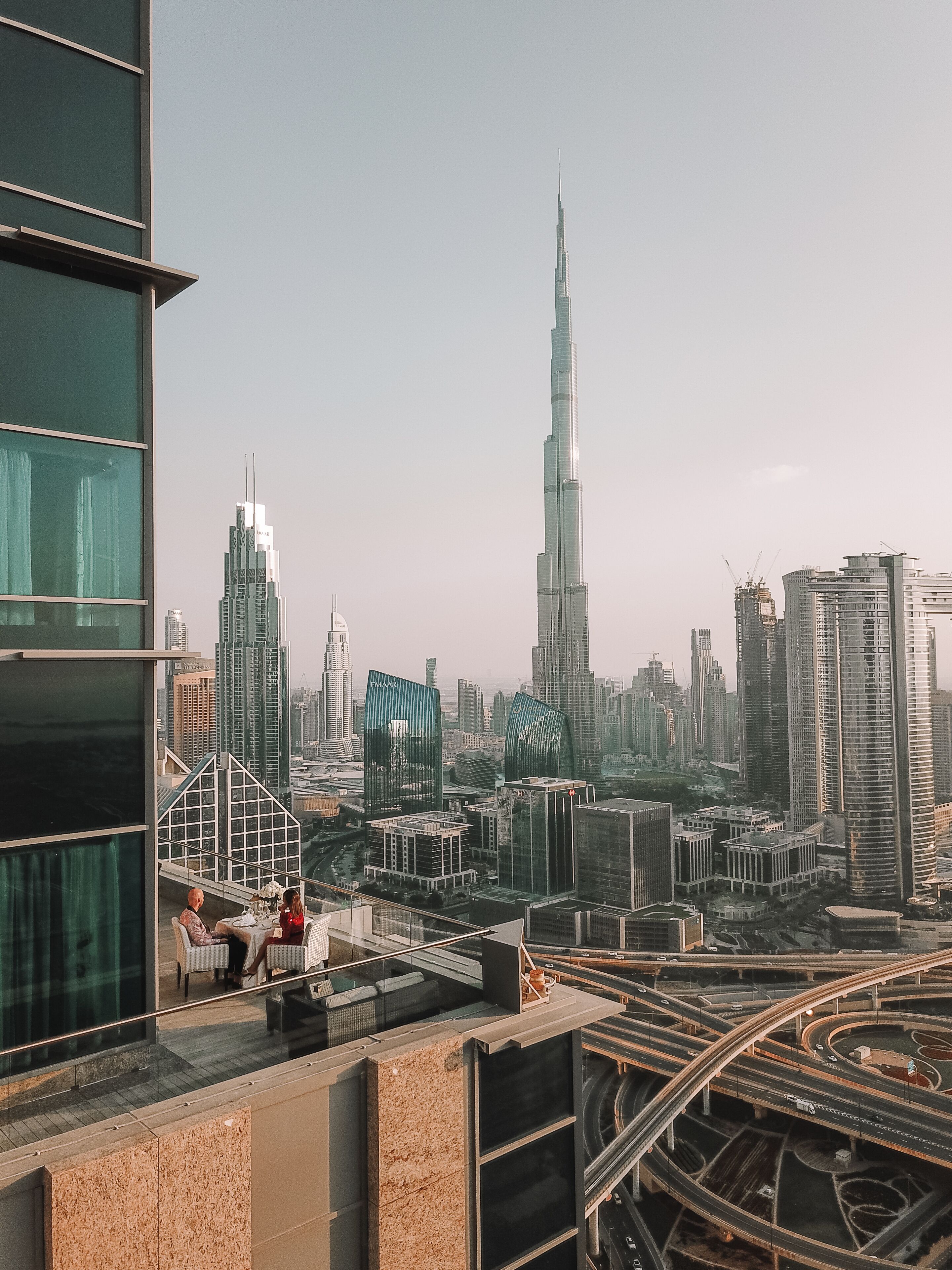 Um edifício alto com vista para o horizonte urbano, incluindo o Burj Khalifa.