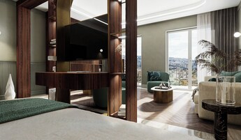 Uma sala de estar moderna com uma televisão de tela plana grande, um sofá, uma mesa de centro e vista para a cidade através de grandes janelas.