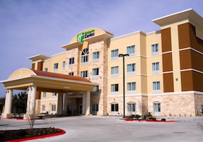 Edifício Holiday Inn Express com entrada coberta, vários andares e estacionamento.
