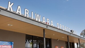 Exterior do Kariba Sports Bar com céu azul ao fundo.