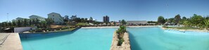Piscina com paisagem ao redor, incluindo edifícios e árvores.