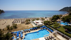 Um resort com piscina, praia e vista para o oceano.