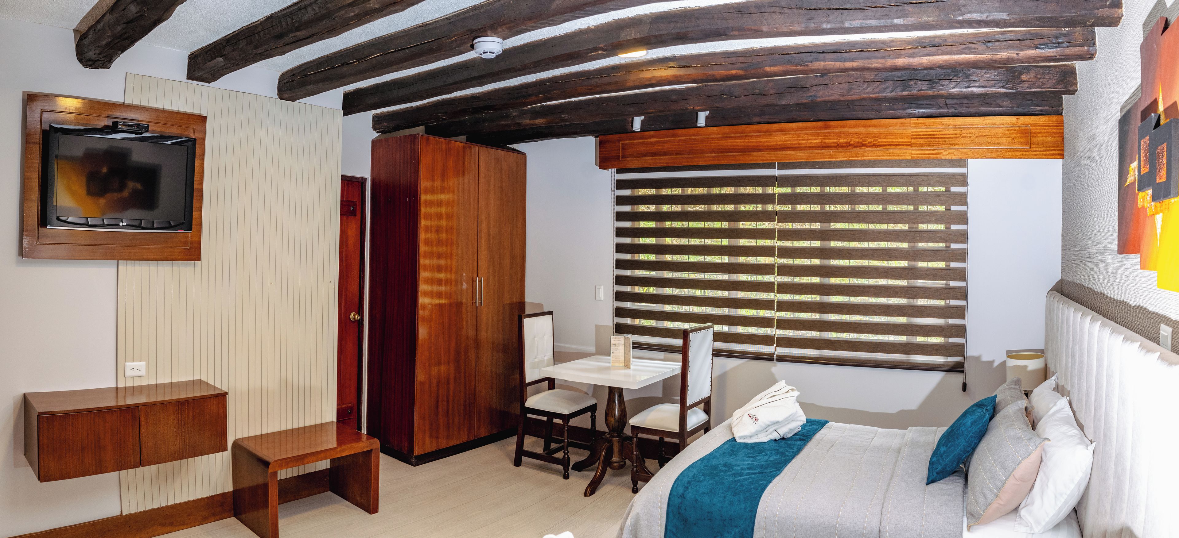 Quarto com cama, escrivaninha e armário.