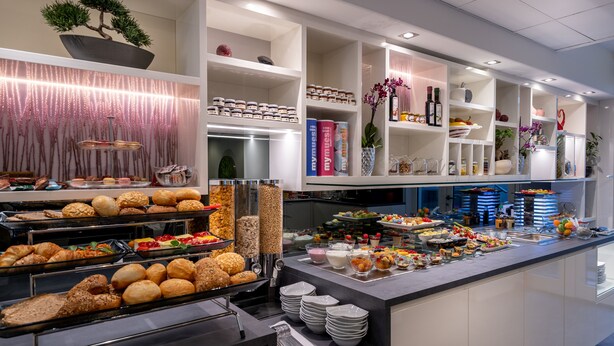 Um buffet com diversos pratos e disposição organizada.