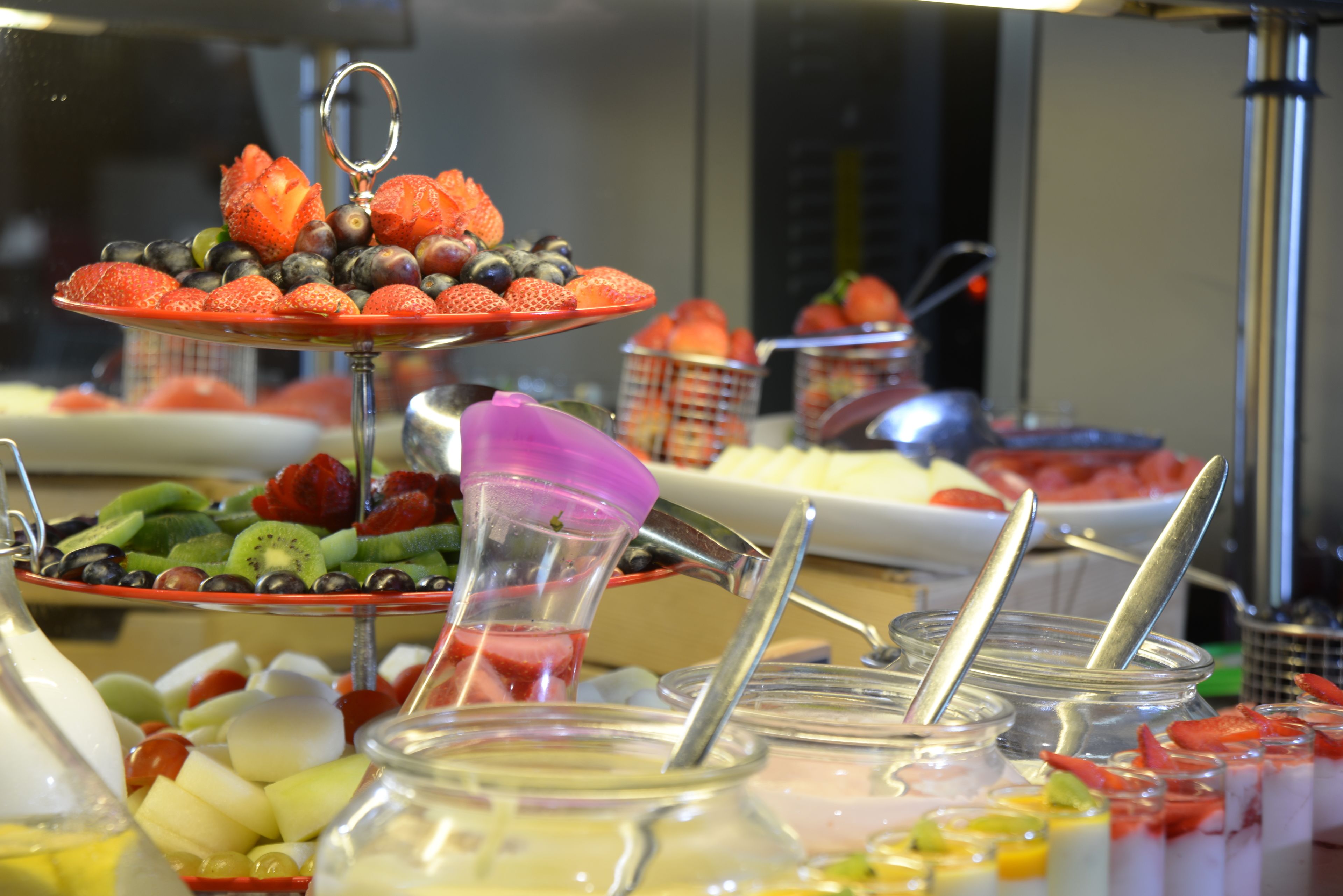 Um buffet com diversas frutas e bebidas.