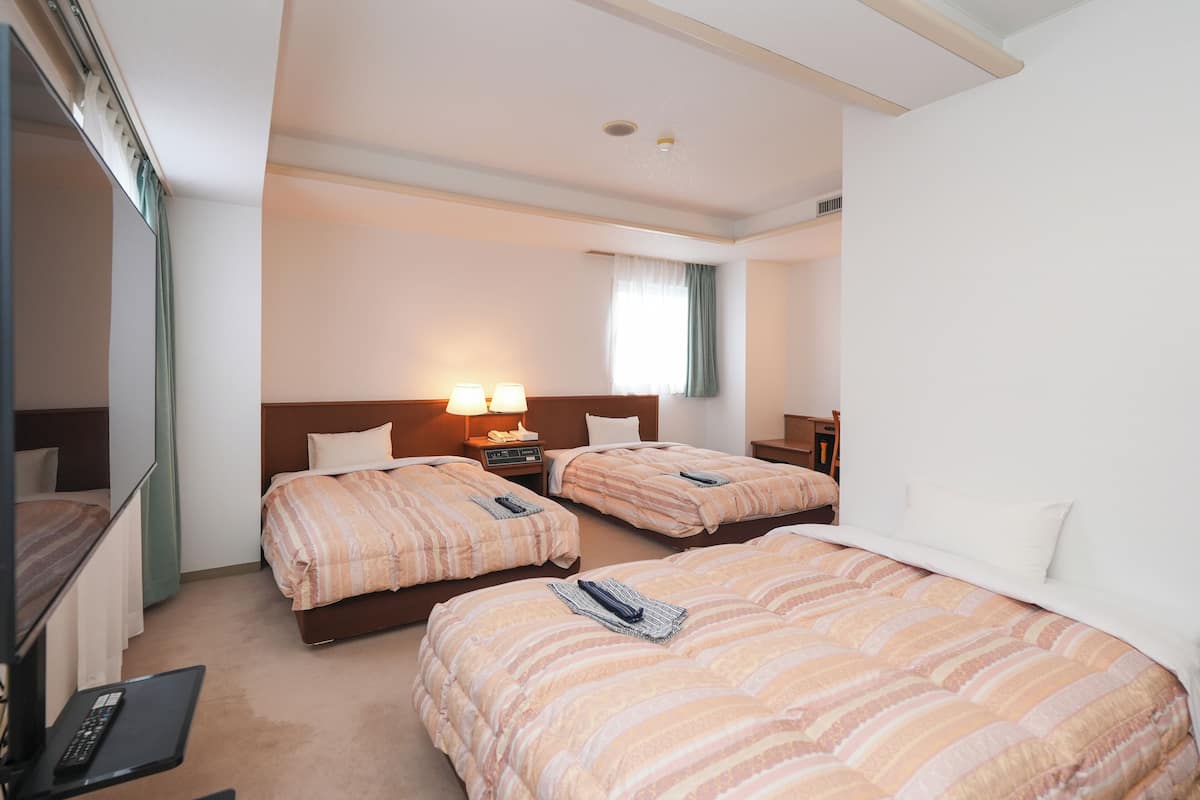 Quarto triplo luxo, 3 quartos, para não fumantes | Escrivaninha, Wi-Fi de cortesia, roupa de cama